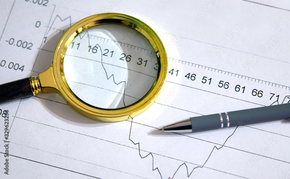 Looking at growth chart with magnifying glass and pen. Graphs, charts ...