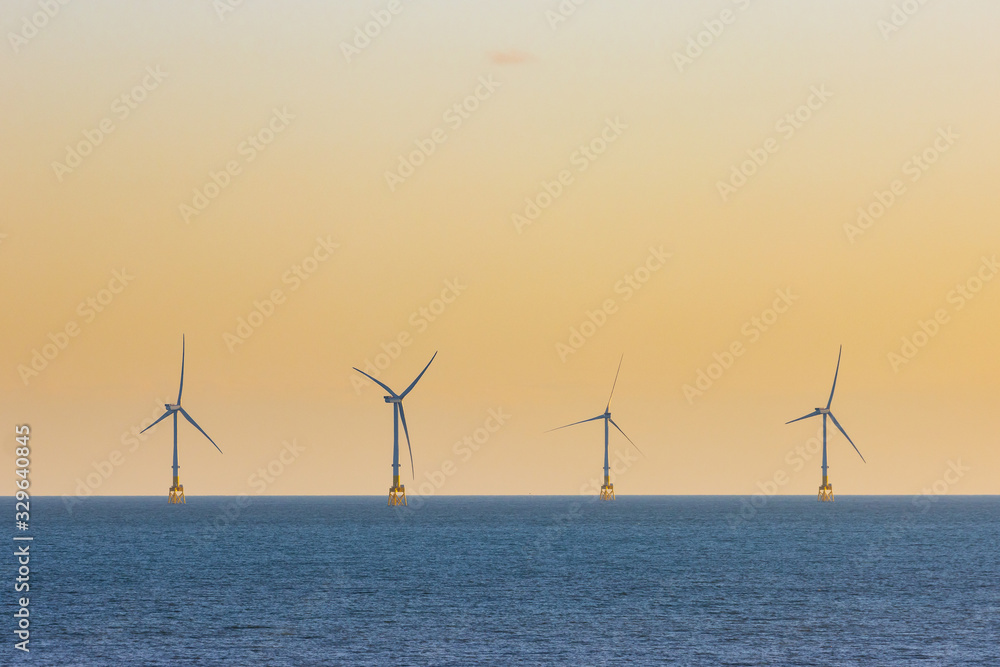 Offshore wind turbines at sunset Stock Photo | Adobe Stock