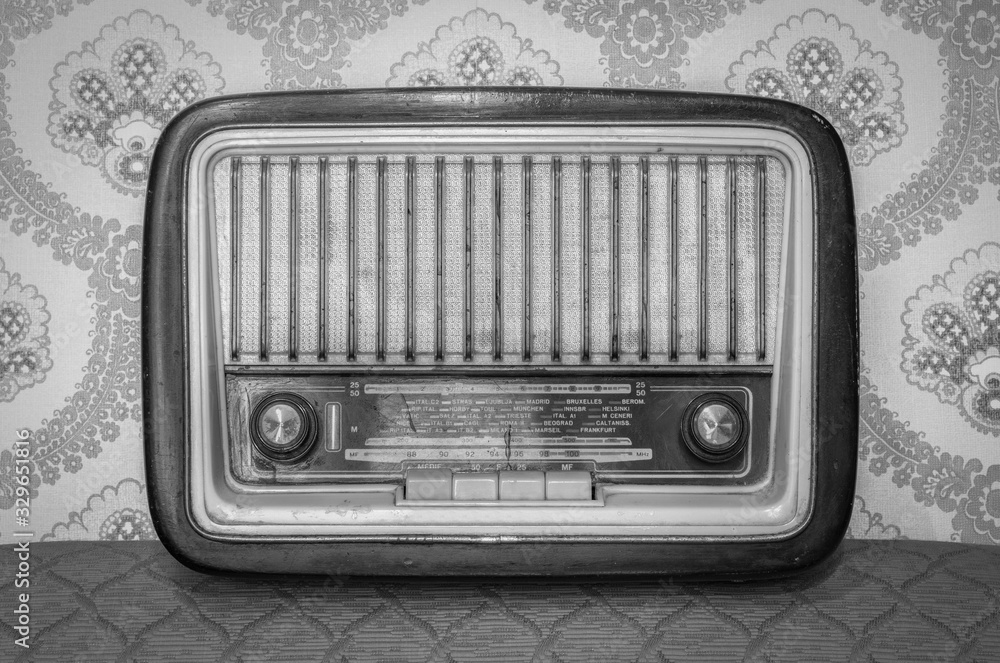 An old transistor radio, with knobs and buttons for manual tuning. In ...