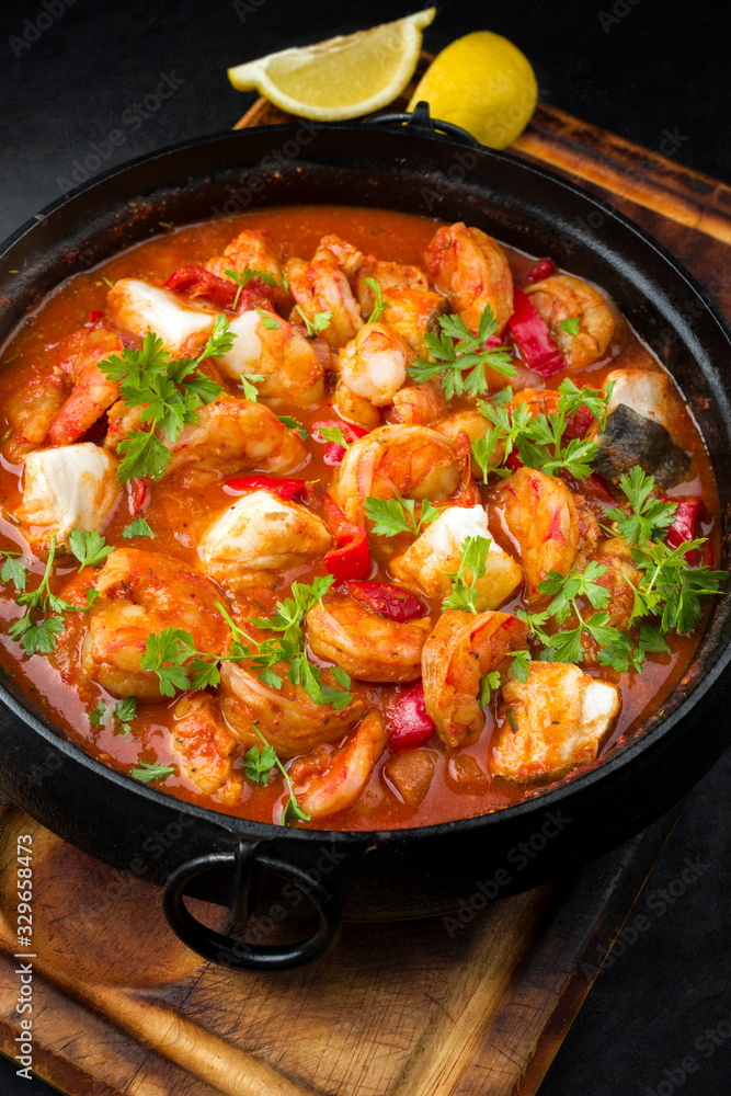 Traditional American fish stew cioppino with prawns, and fish as ...
