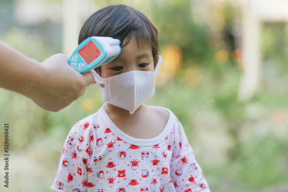 Doctor measuring temperature cute baby boy at hospital . Mother takes ...