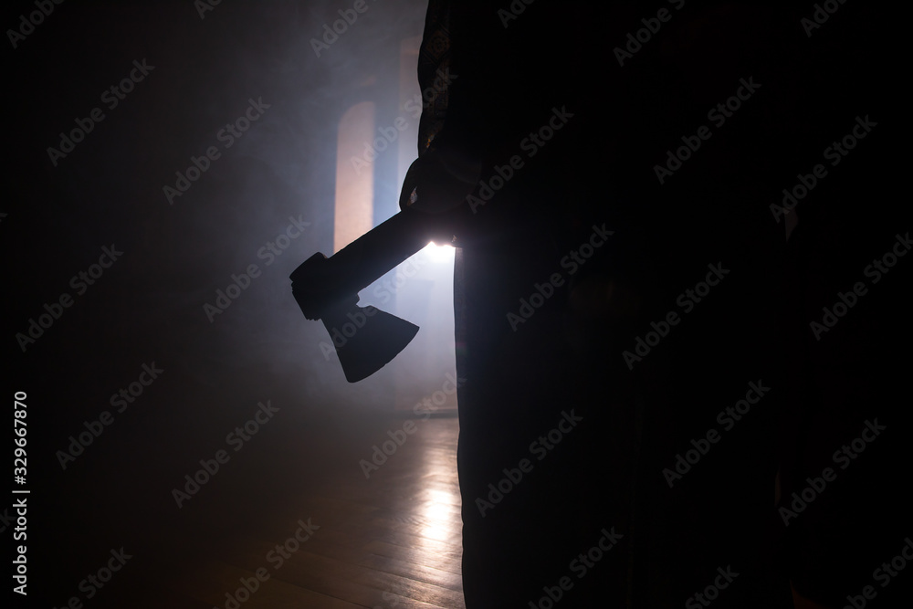 Silhouette of an unknown shadow figure on a door through a closed glass ...