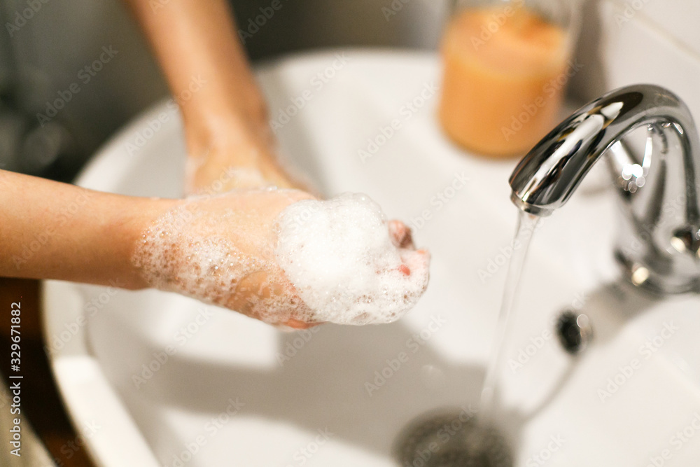 Washing hands. Hands washing with soap foam on background of flowing ...