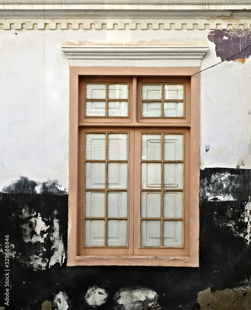 Simple old style wooden frame window, closed. Detail of an old villa ...