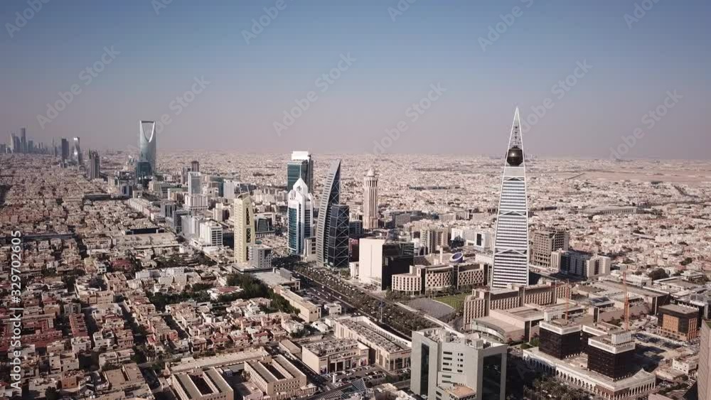 Flying towards modern skyline of downtown Riyadh along King Fahd Road ...