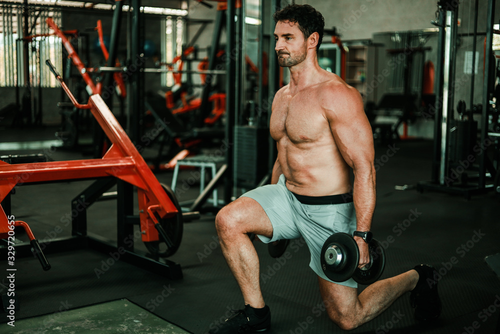 Handsome Man exercise in gym body-building with muscular strong body ...