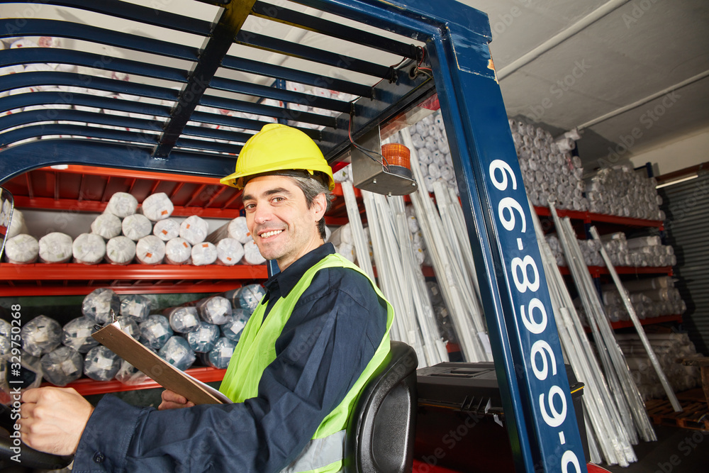 Smiling forklift driver on the forklift Stock Photo | Adobe Stock
