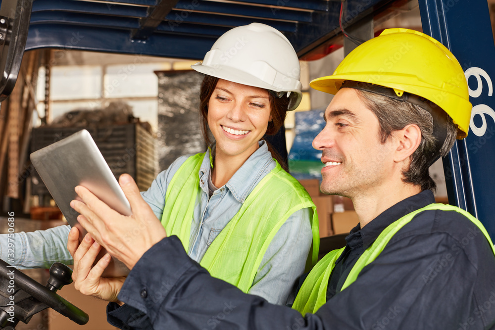 Two warehouse workers with tablet computer Stock Photo | Adobe Stock