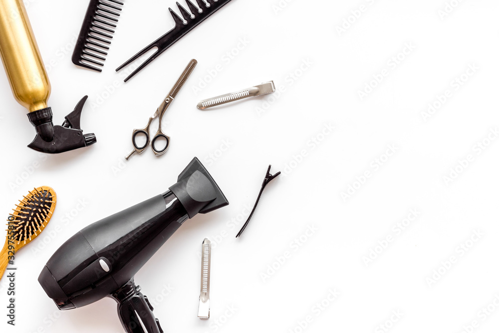 Professional hairdressing set with combs and hairdryer on white ...