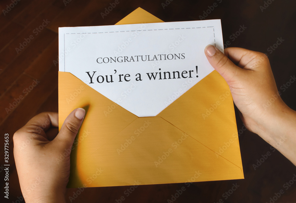 An open shiny gold envelope with a letter that says Congratulations You ...