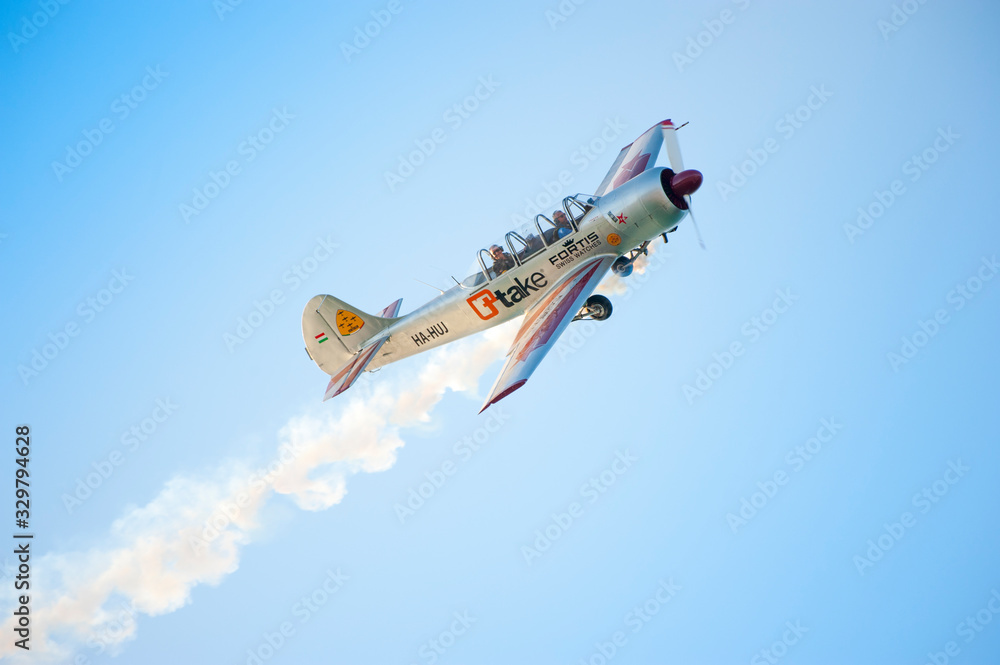 Acrobatic airplane with smoke signal Stock Photo | Adobe Stock