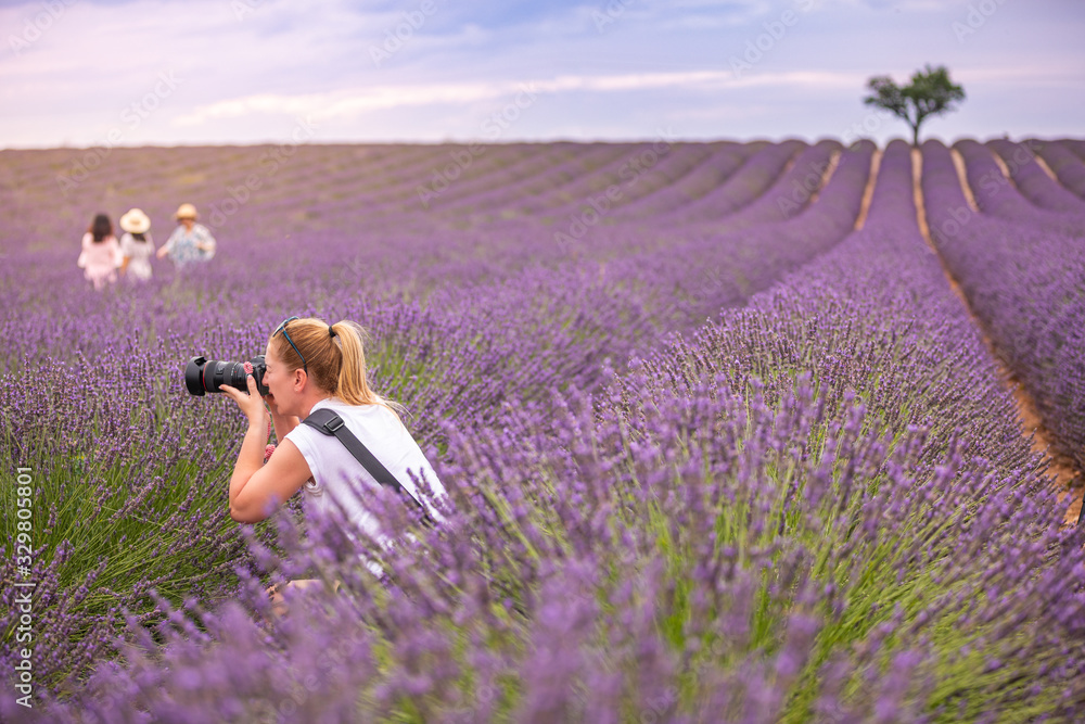 Beautiful woman taking picture outdoors with a DSLR camera. Young ...