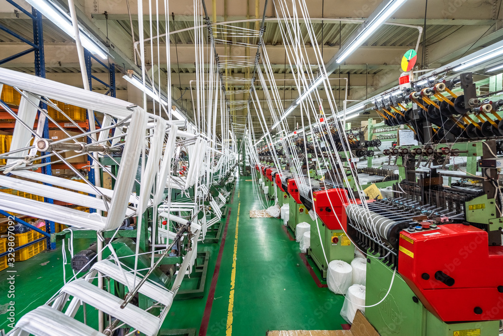 Elastic weaving workshop at textile factory in industrial zone in Ho ...