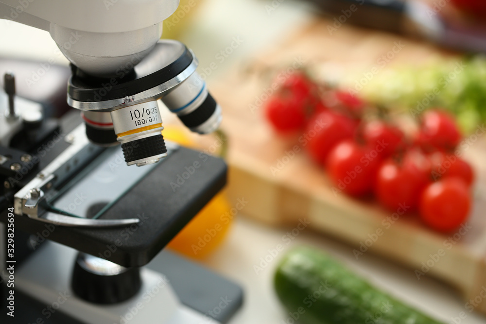 Microscope head on kitchen background vegetables concept nitrates Stock ...