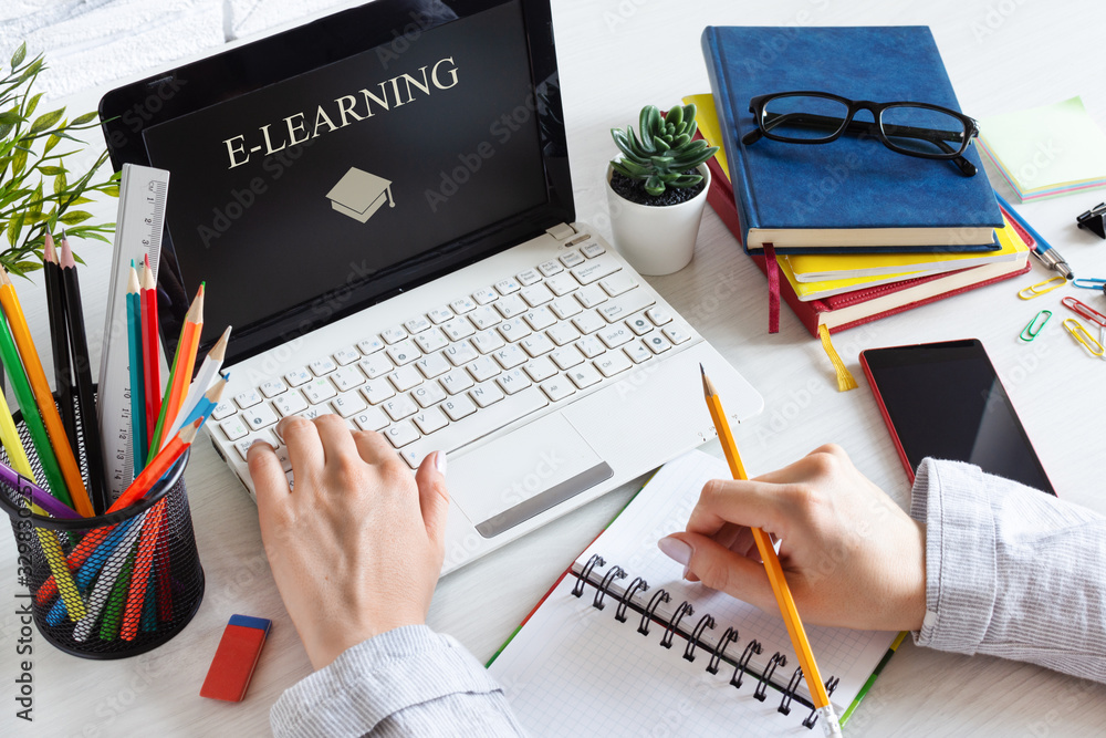 Woman hands using laptop. Workplace with computer and books. E-learning ...