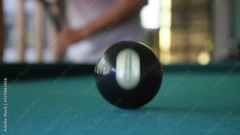 Vidéo Stock A man hits the eight billiard ball and hits the lens of the ...