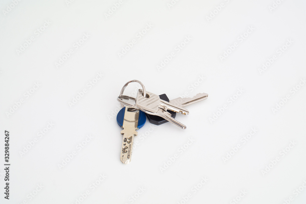 Key ring with different types and shapes of keys close up shot isolated ...