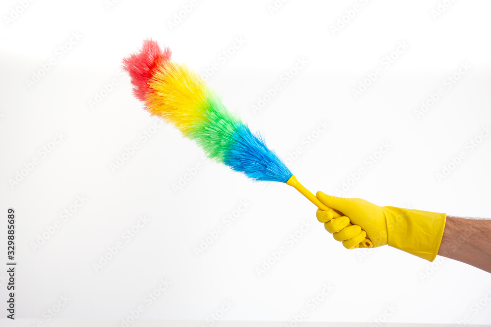 White Caucasian male hand with yellow latex glove holding a rainbow ...