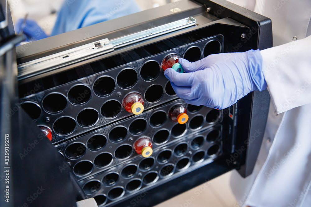 Gas chromatograph - mass spectrometer equipment with vials in lab with ...