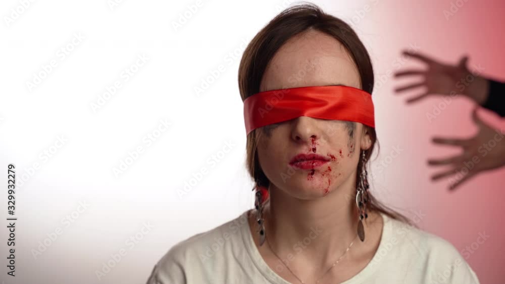 Video „Tired and beaten woman with red ribbon on eyes and bleeding nose ...