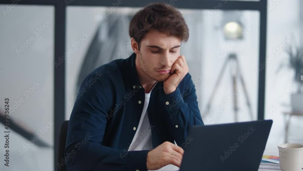 Boring business man looking computer screen in office. Tired guy ...
