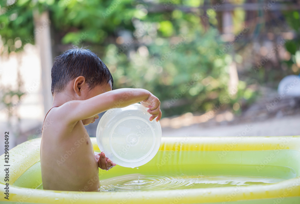 Shirtless Boy Playing With Container In Wading Pool Stock Photo | Adobe ...