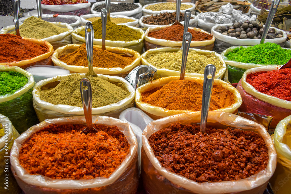 Colorful spices of many varieties stacked up for sale in traditional ...