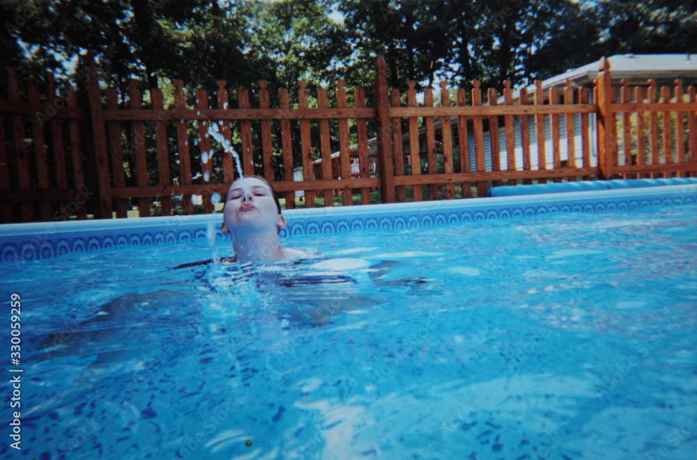 Woman Spitting Water From Mouth While Swimming In Pool Stock Photo ...