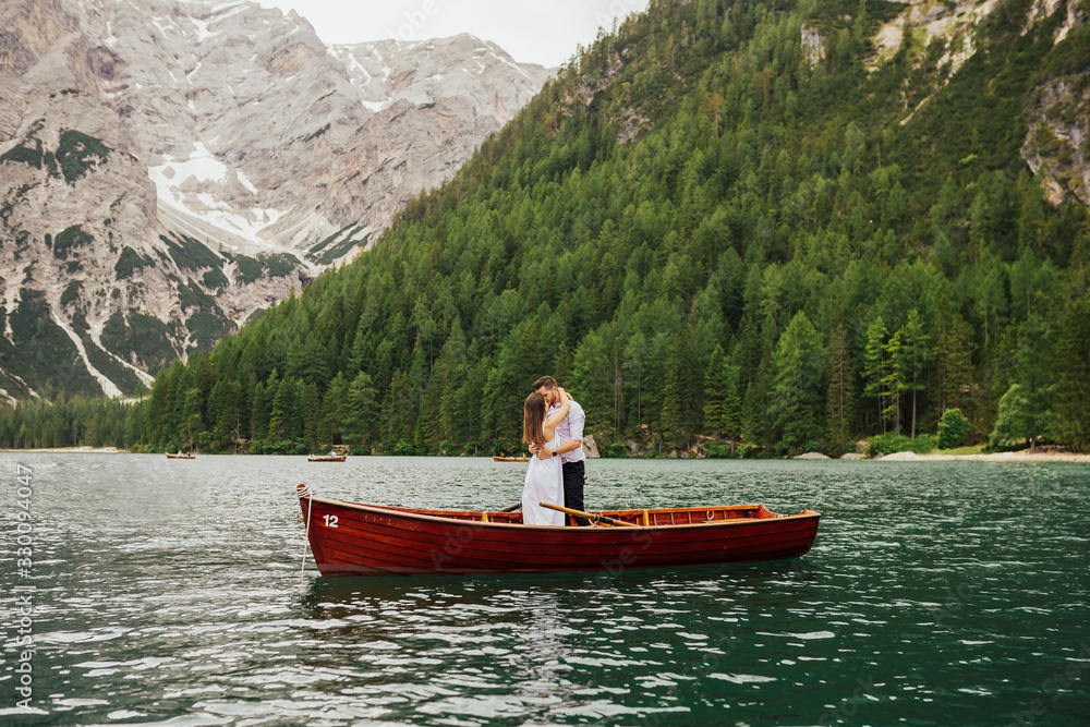Tender couple on a wonderful lake and mountains with amazing view ...