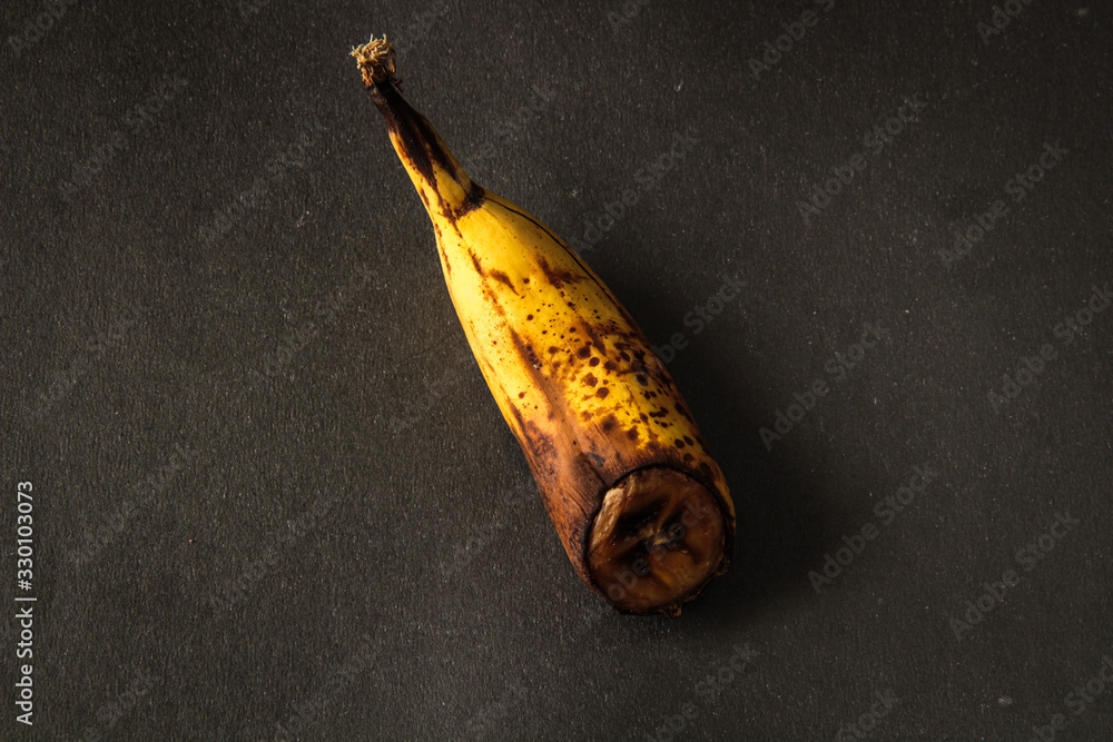 Banana, half banana, spoiled banana on a in black background. Organic ...