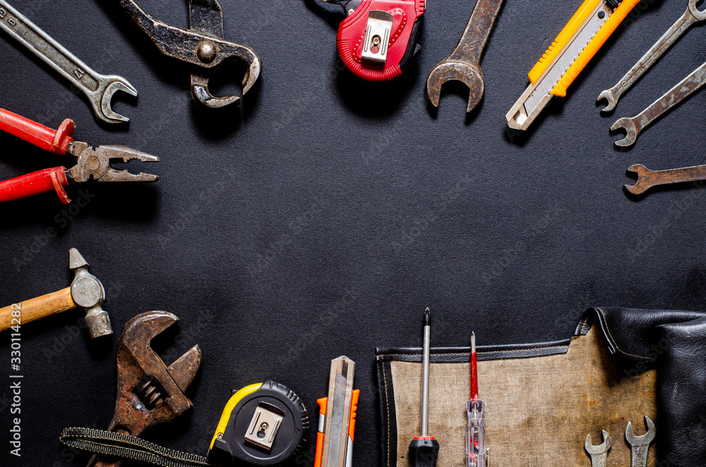 Tools for repair and reconstruction in home conditions lie on a black ...