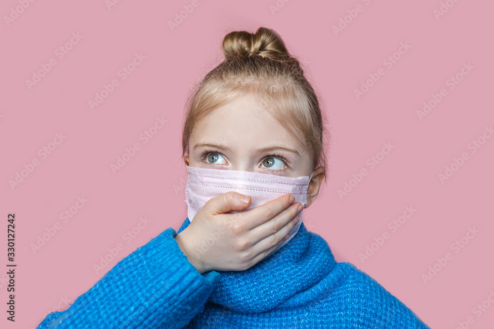 Danger of the virus. A small blonde girl in a gauze mask looks at the ...