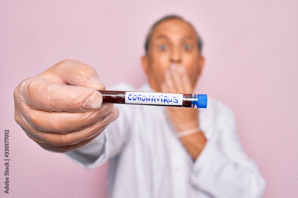 Senior handsome hoary man holding coronavirus tube test over isolated ...