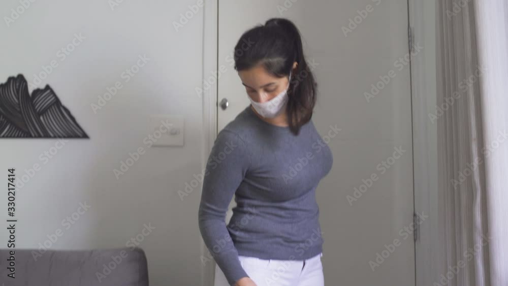woman wears white mask arriving home and sanitizing hands preventing ...
