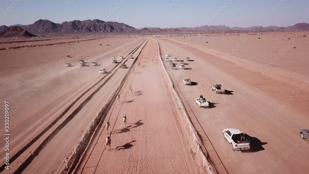 Drone flight of spectacular camel race with jeeps and SUVs, beautiful ...