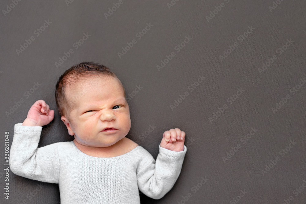 Newborn baby emotions, white background. Funny face of a child ...