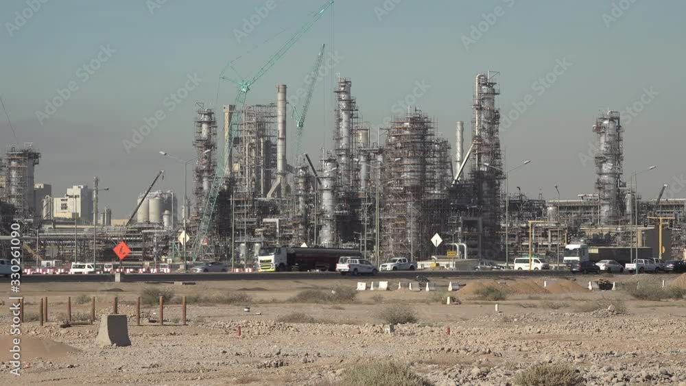 Traffic drives past oil refineries and industrial plants (partly under ...
