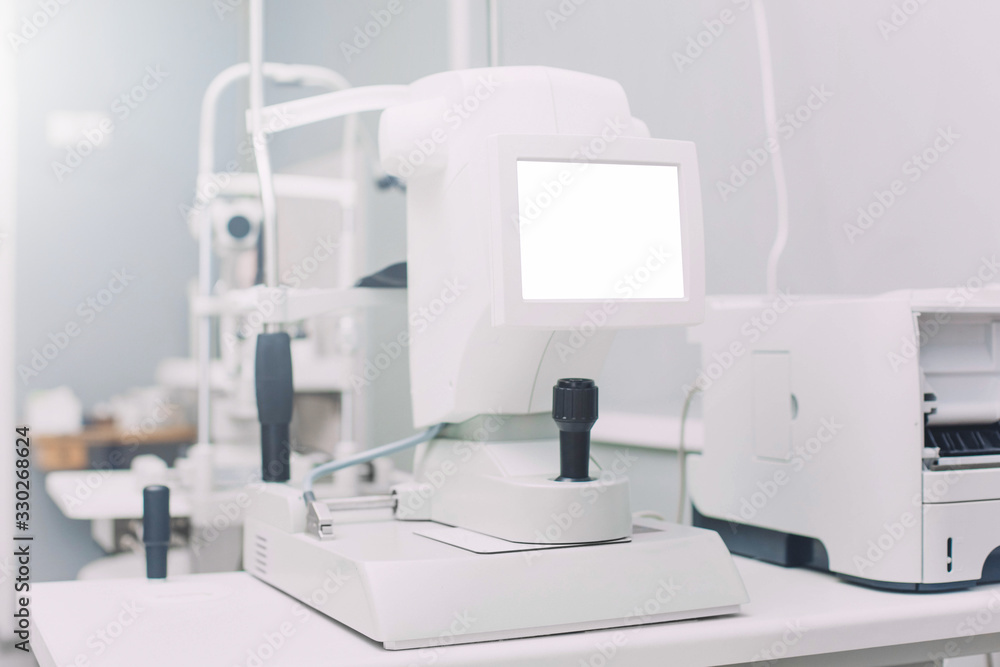 Auto Kerato Refractometer standing on a table in doctors office with ...