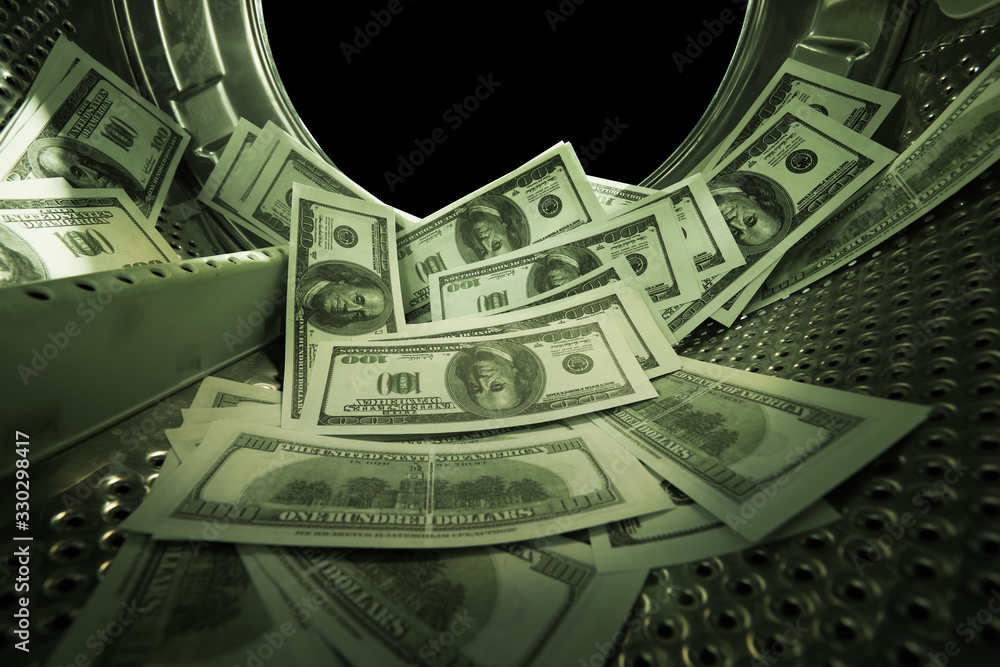 Washing banknotes in machine, money laundering, financial fraud concept ...