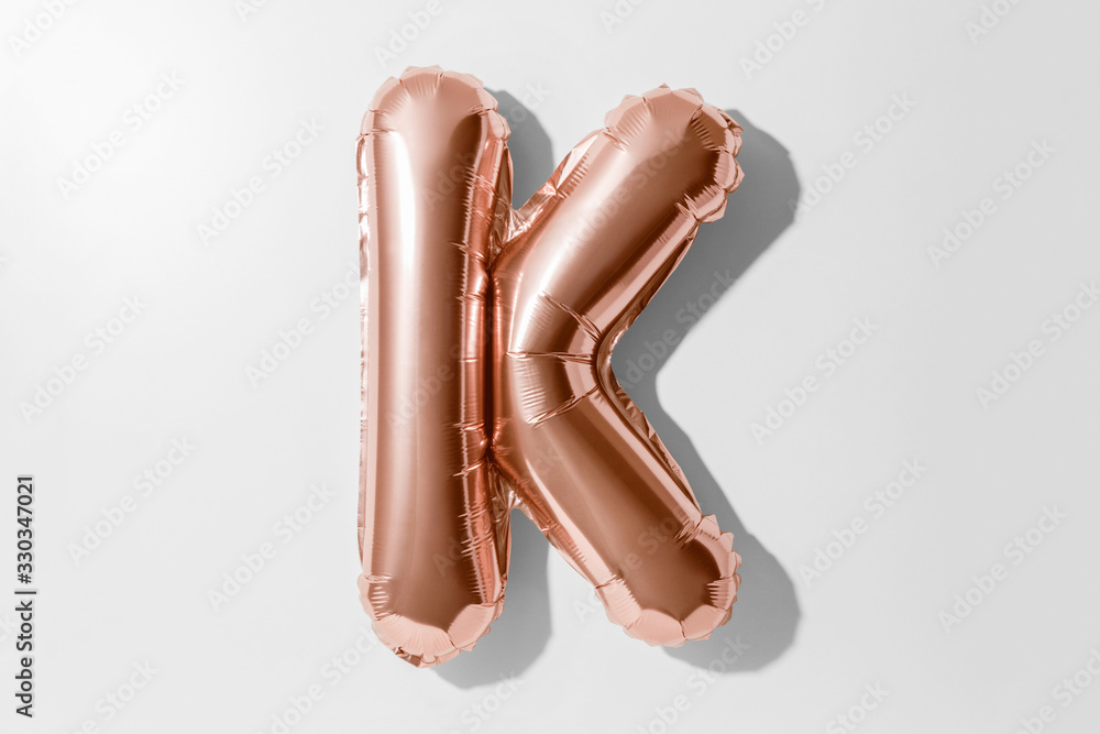 Letter K, Rose gold foil balloon alphabet isolated on white background ...