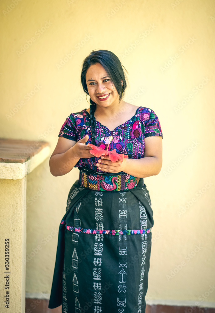 mayan lady with a flower in traditional outfit in Panajachel, Guatemala ...