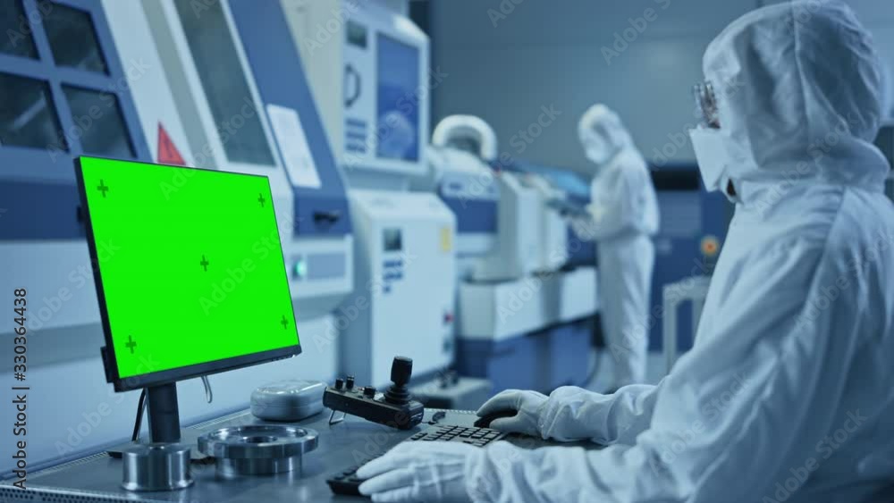 Factory Cleanroom: Engineer Wearing Coveralls Does System Control on ...