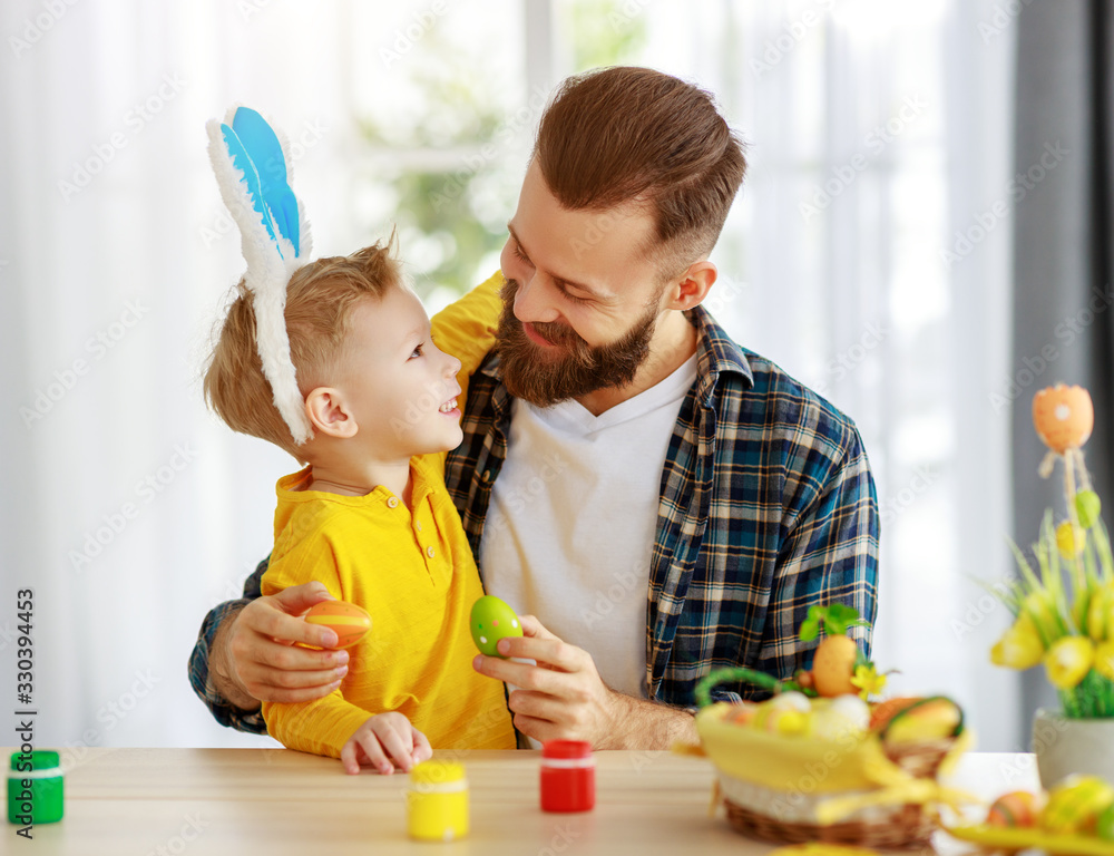 Happy easter! family father and child with ears hare getting ready for ...