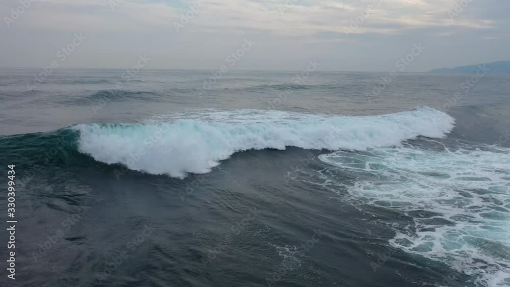 Long ocean wave in shape of pipe going to beach in 4K. surf white foam ...