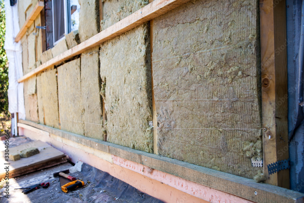 warming the walls of a stone house with a stone wool heater. Ecological ...