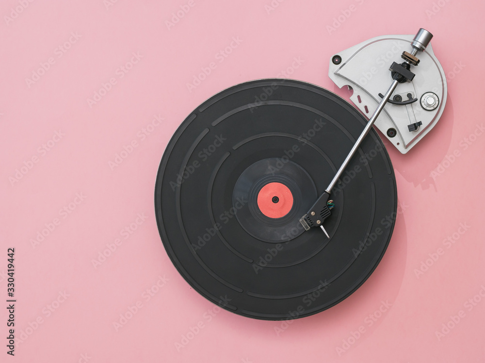 Vintage record player with a red vinyl disc on a pink background. Stock ...