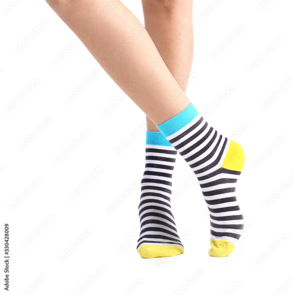 Legs of young woman in socks on white background Stock Photo | Adobe Stock
