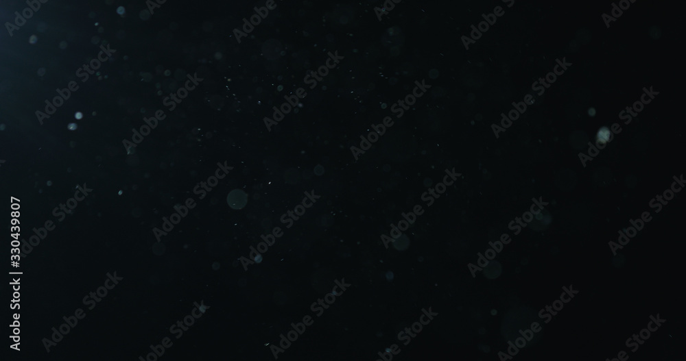 natural dust particles float in air on black background Stock Photo ...