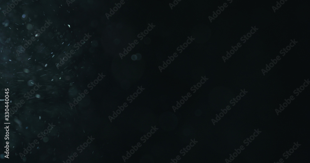 natural dust particles flow in air on black background Stock Photo ...