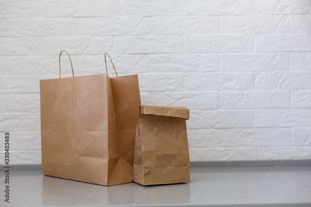 Paper bag on table against white background. Mockup for design Stock ...